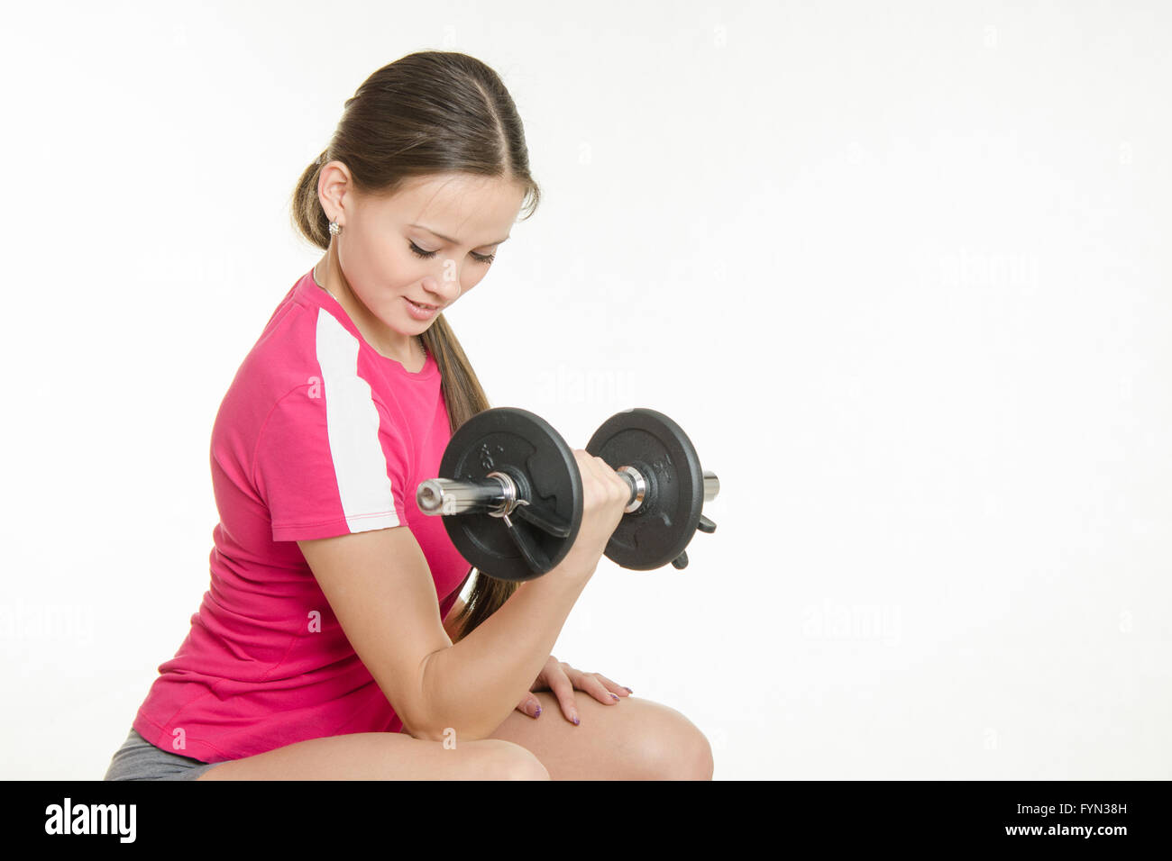 She shakes dumbbell arm muscles Stock Photo - Alamy