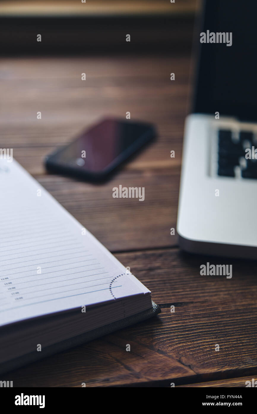 Laptop and diary on the desk Stock Photo - Alamy