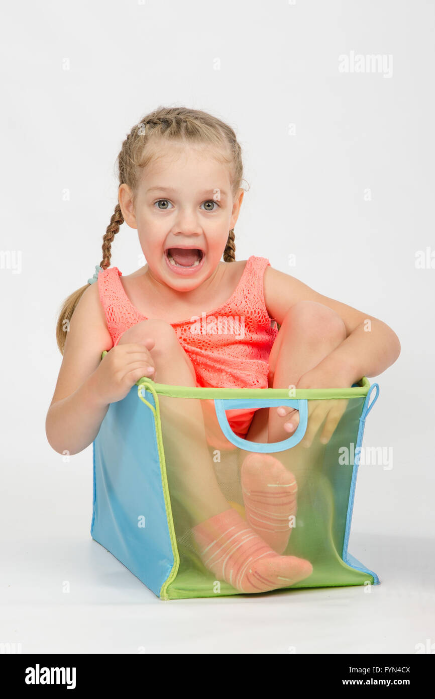Happy girl in a box for toys Stock Photo - Alamy