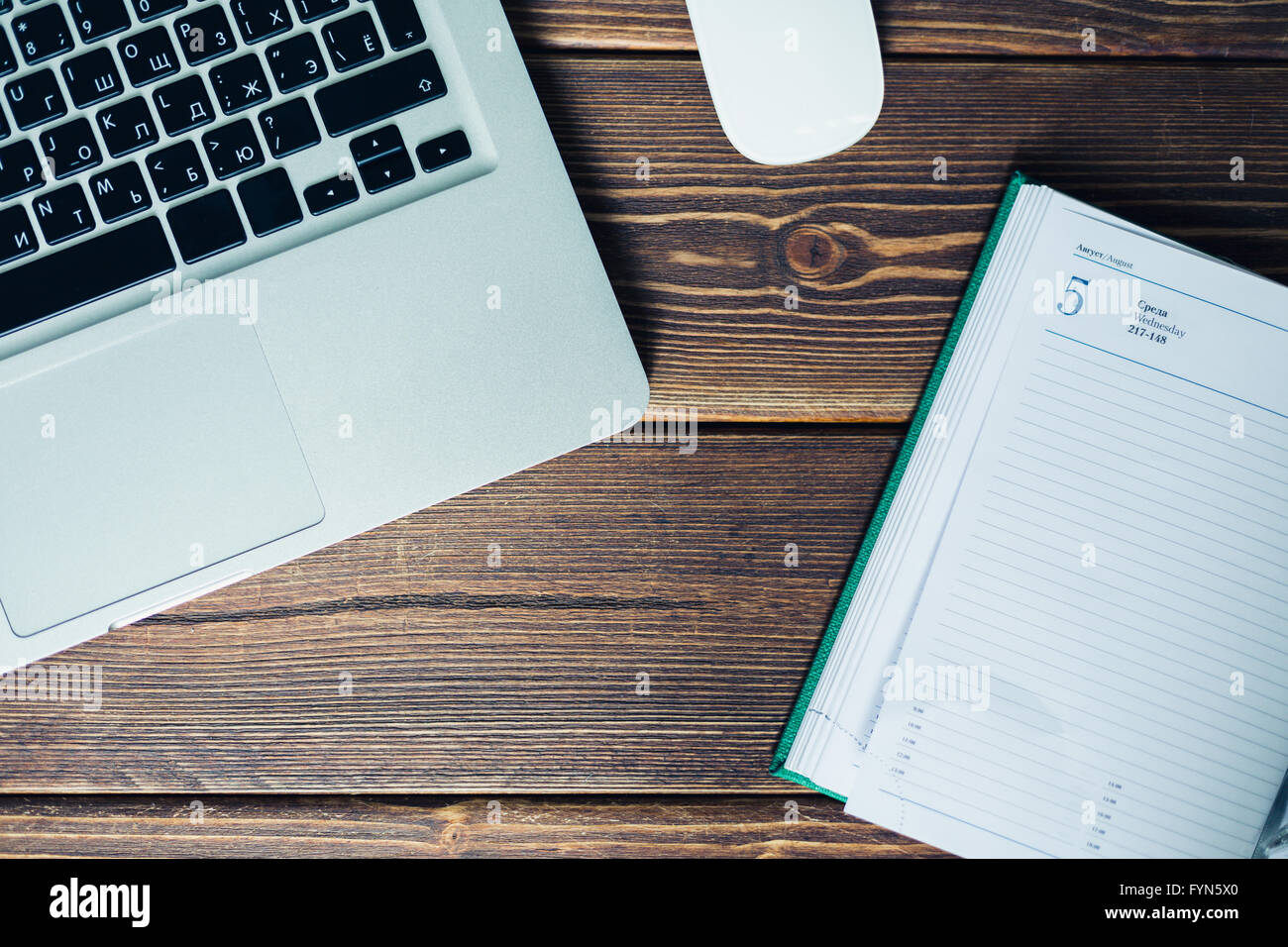 Laptop and diary on the desk Stock Photo - Alamy