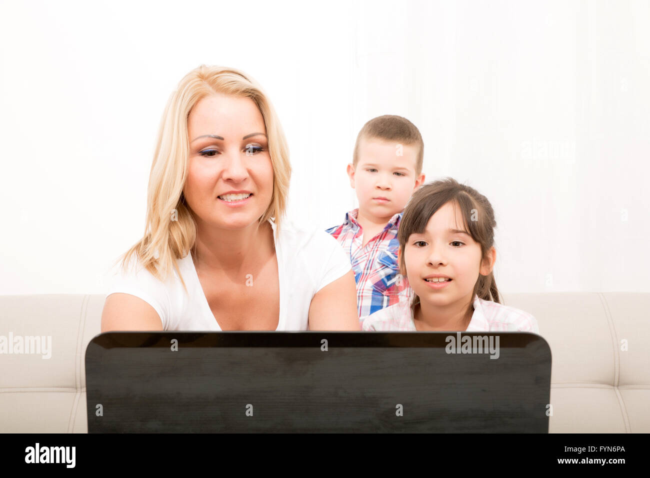 Mother with her Kids using a Laptop computer Stock Photo - Alamy