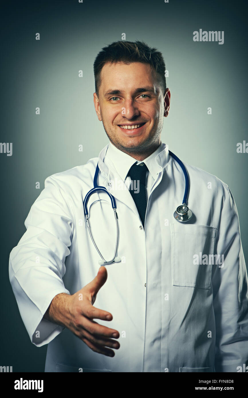 Medical doctor with stethoscope giving hand for handshaking Stock Photo ...