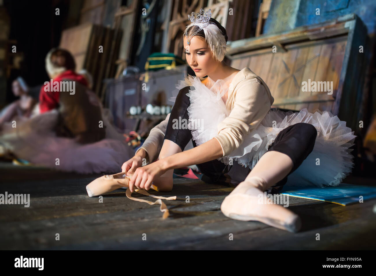 Ballerina sitting on the warm-up backstage Stock Photo - Alamy