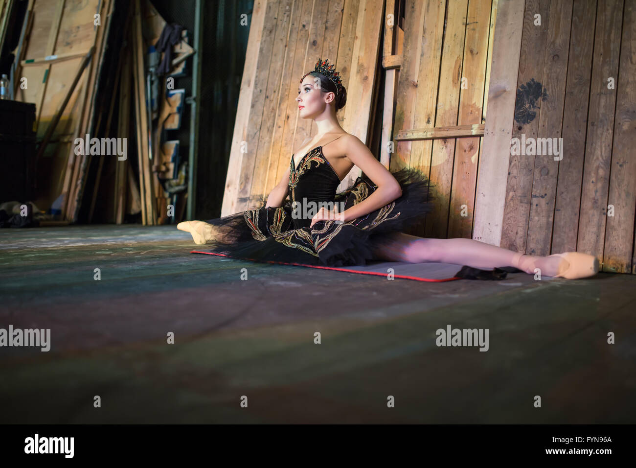 Ballerina sitting on the warm-up backstage Stock Photo - Alamy