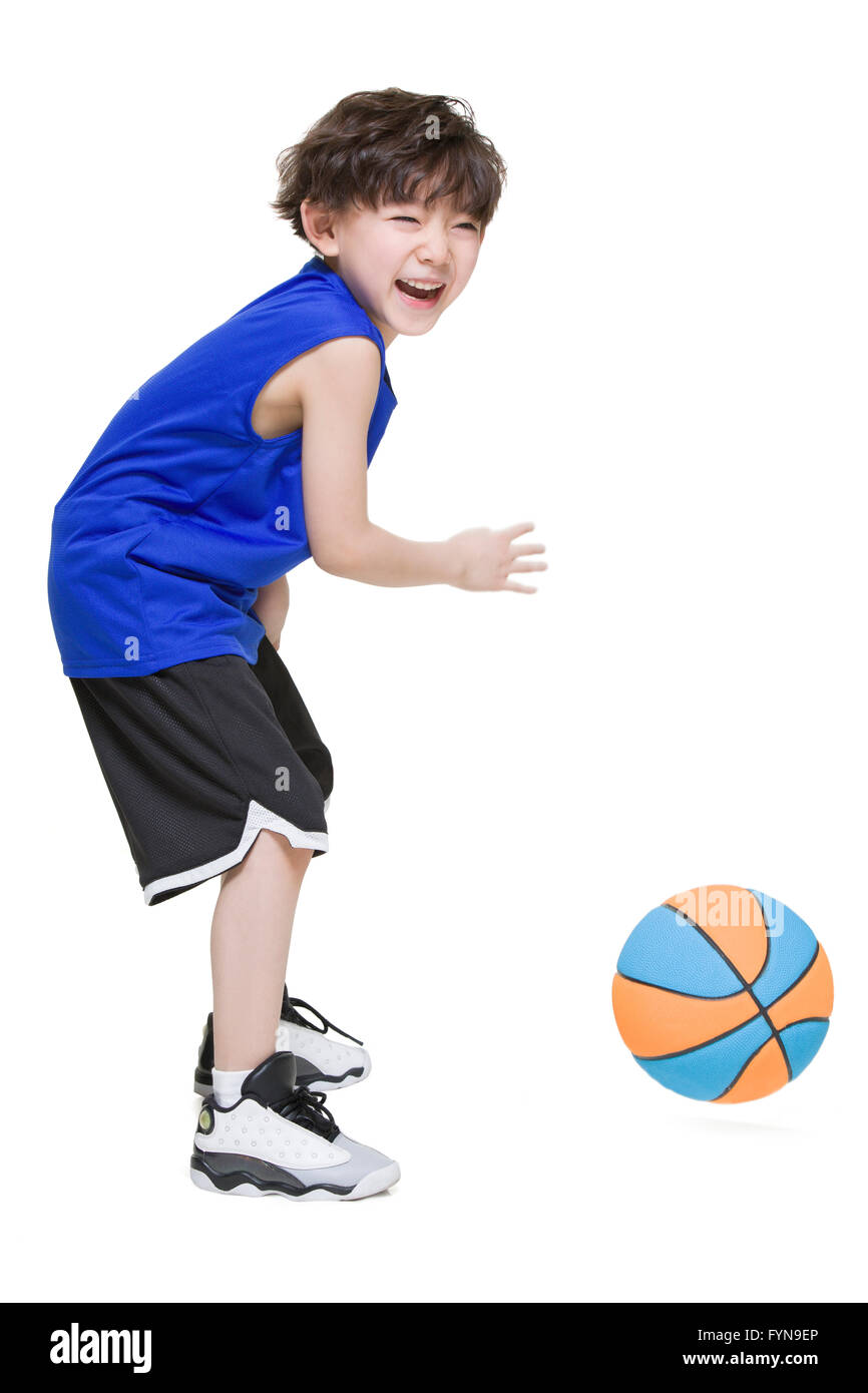 Cute boy playing basketball Stock Photo - Alamy