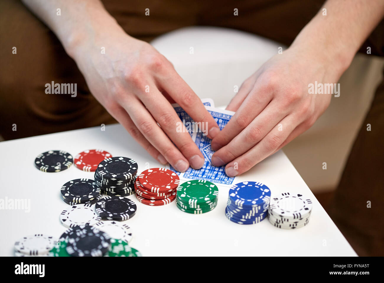 close up of male hand with playing cards and chips Stock Photo - Alamy