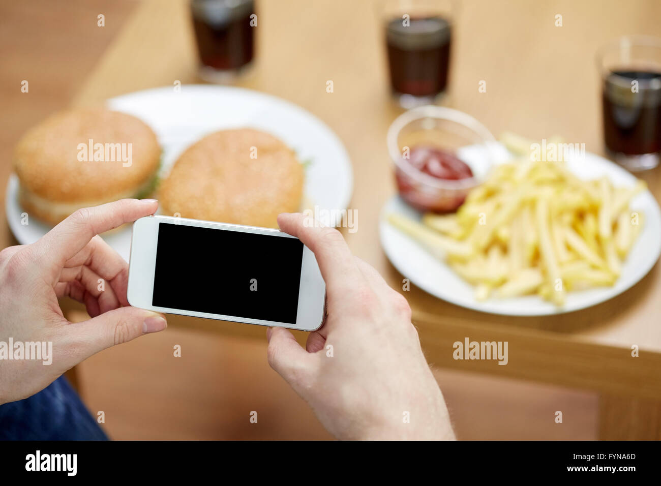 close up of man with smartphone picturing food Stock Photo - Alamy