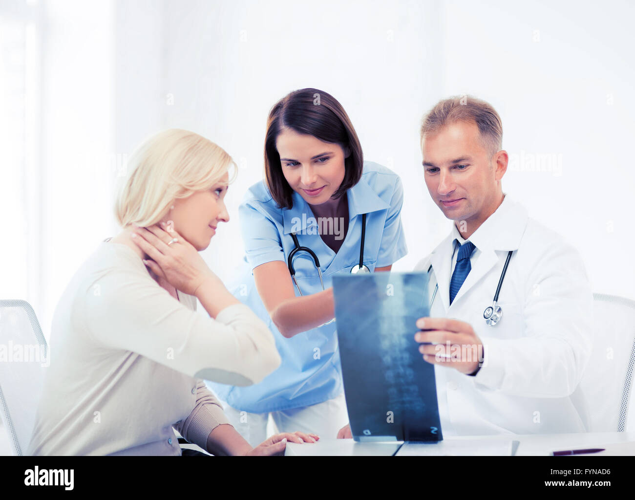 doctors with patient looking at x-ray Stock Photo - Alamy