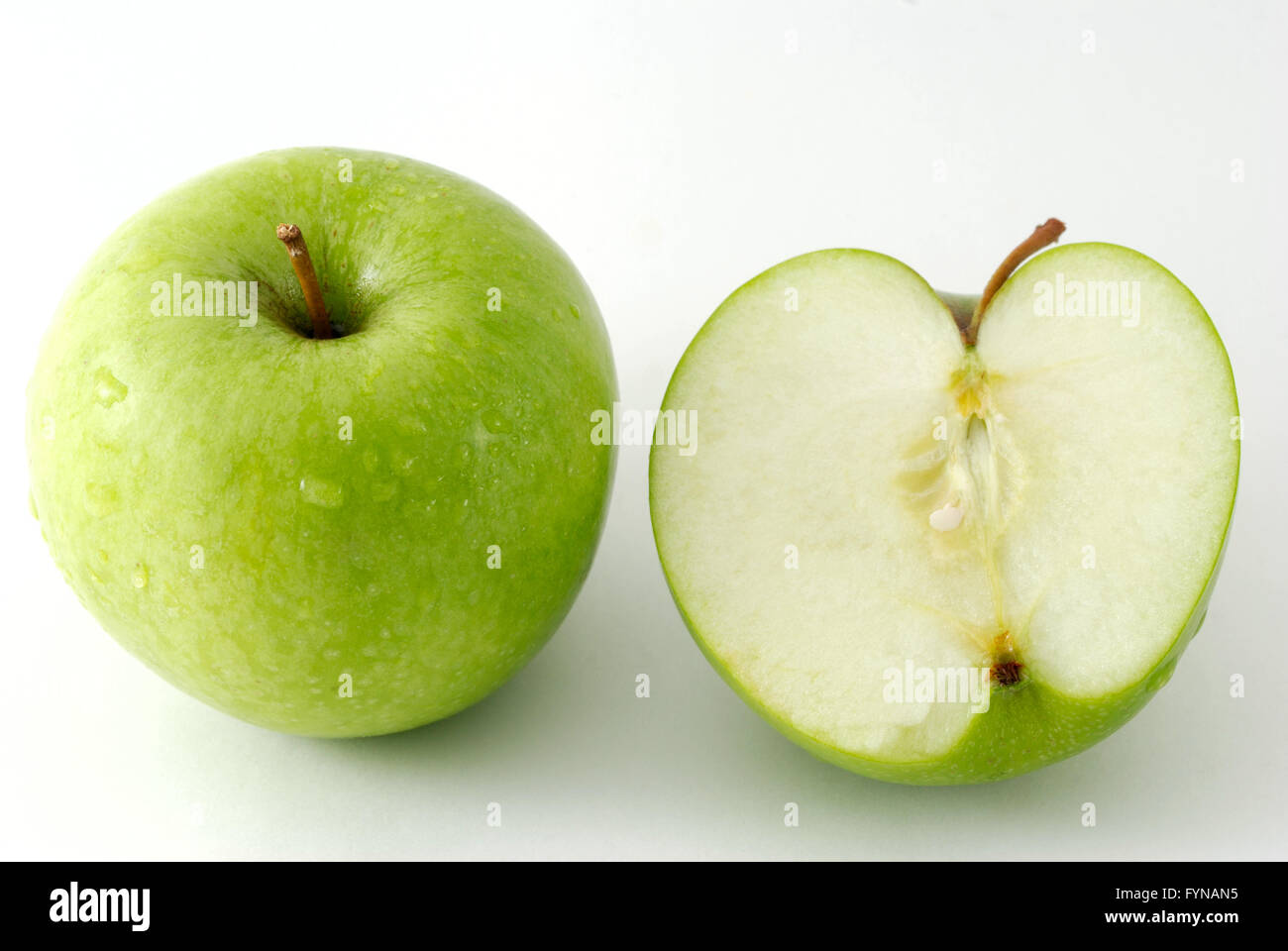 Green apple and half another Stock Photo - Alamy