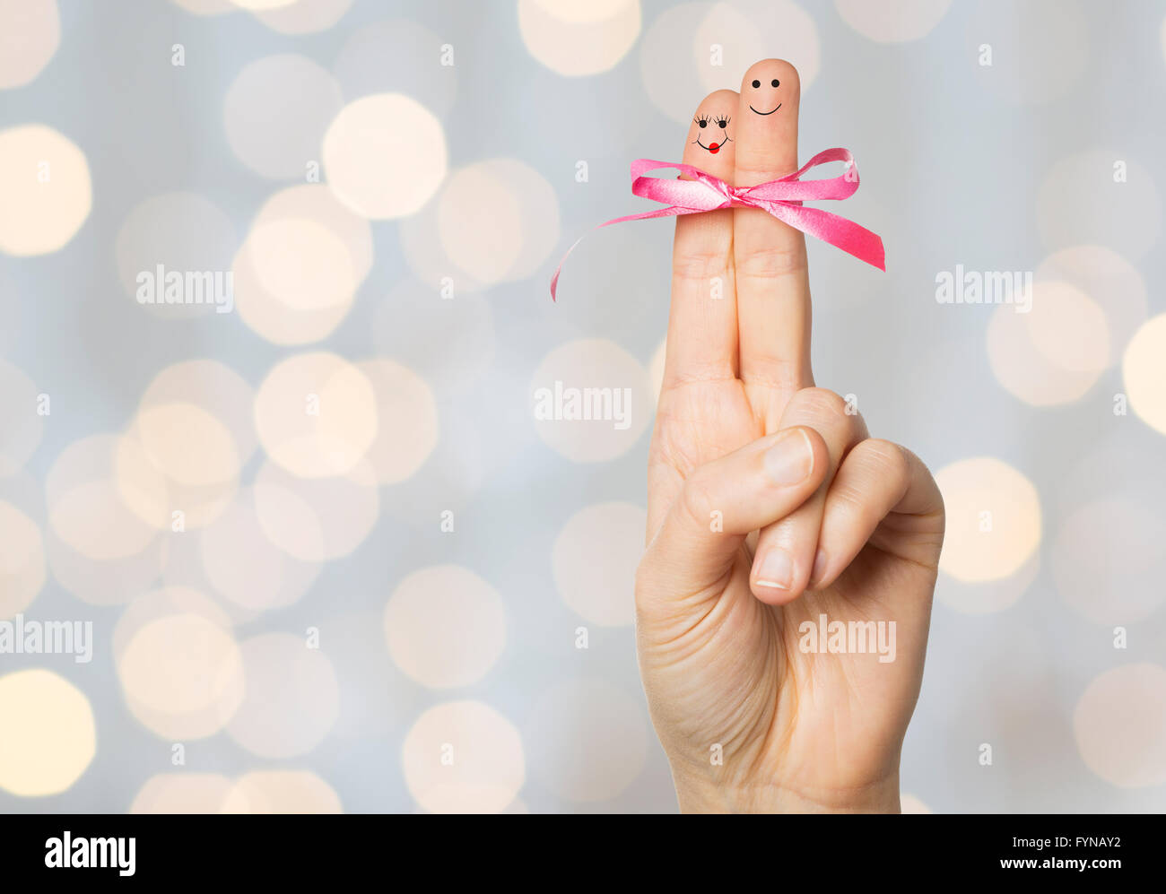 close up of two fingers tied by pink bow knot Stock Photo - Alamy