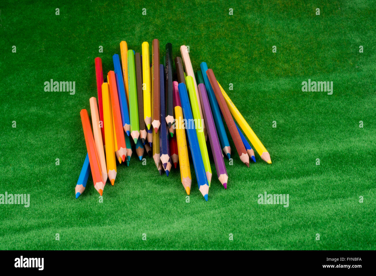 Color pencils scattered on green grass Stock Photo - Alamy