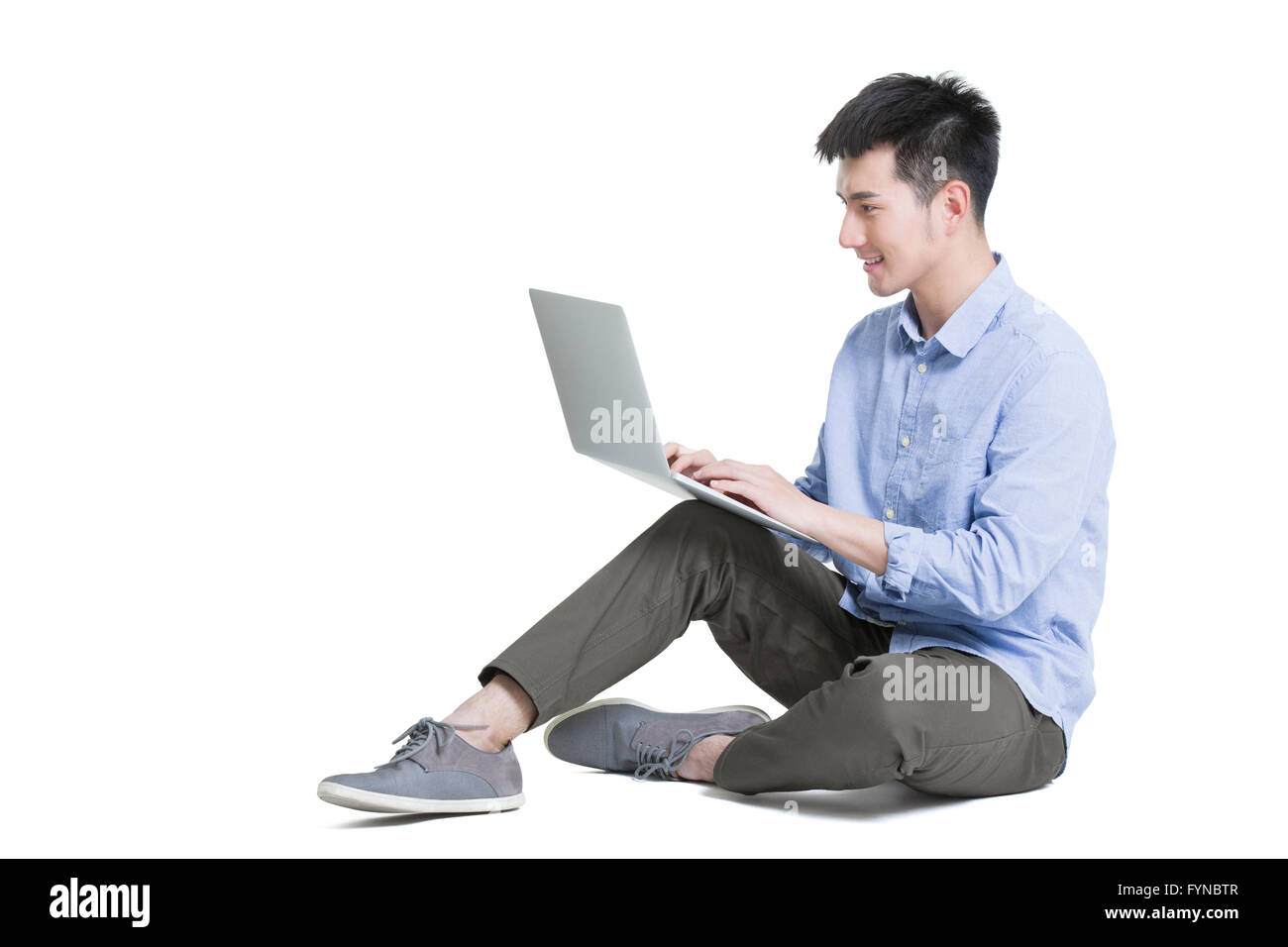 Young man using laptop Stock Photo - Alamy