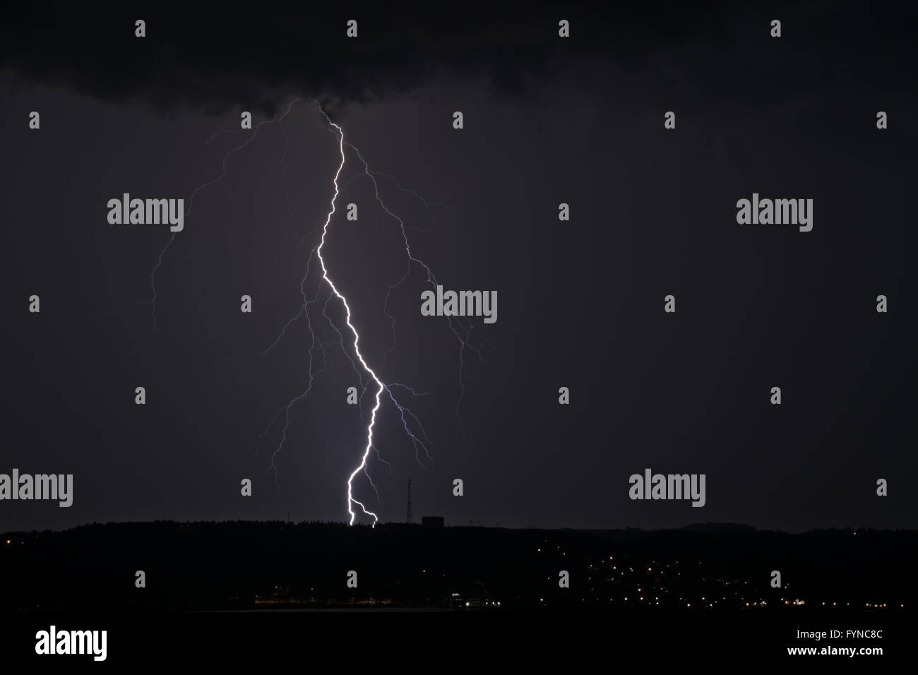 Lightning between clouds and earth Stock Photo - Alamy