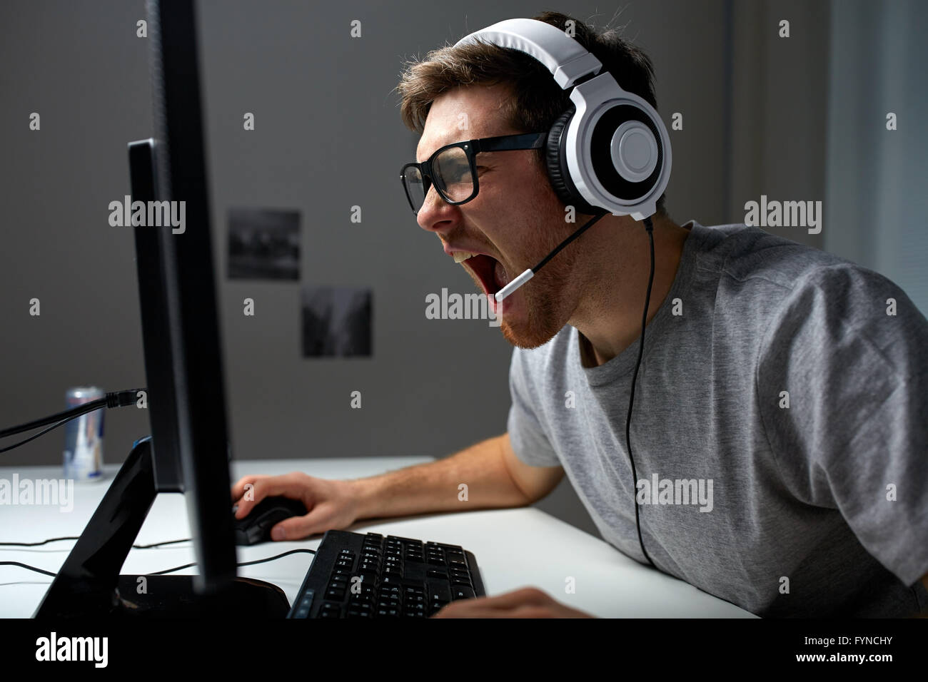 man in headset playing computer video game at home Stock Photo - Alamy