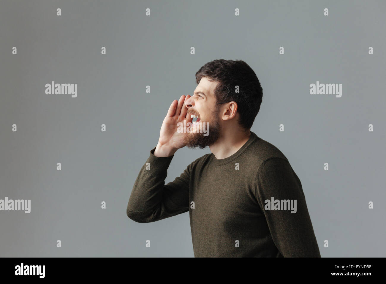 Side view portrait of a man shouting over gray background Stock Photo ...