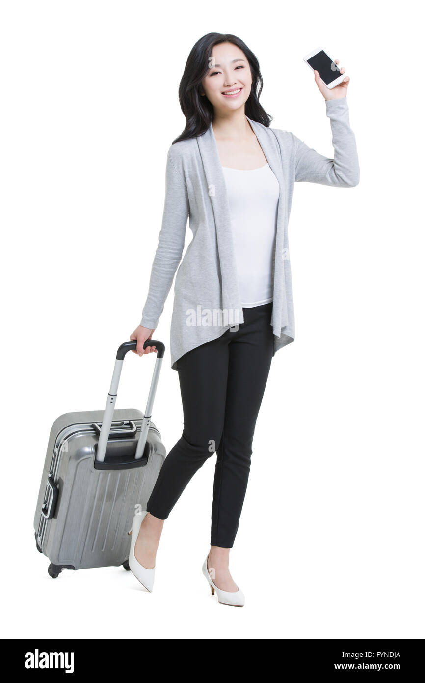 Young woman pulling wheeled suitcase hi-res stock photography and ...