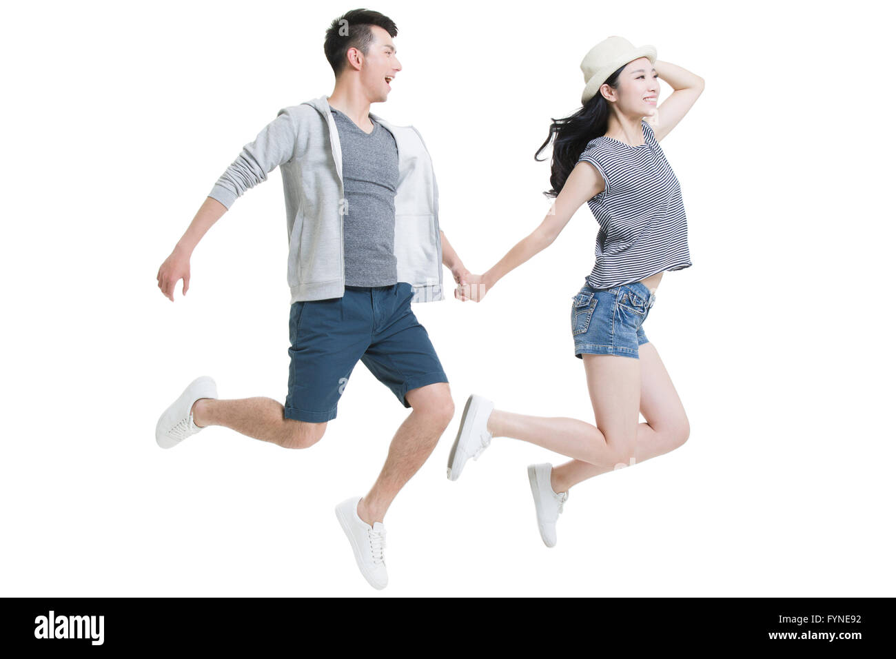 Happy young couple flying Stock Photo - Alamy