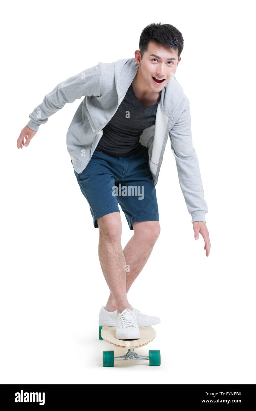 Happy young man skateboarding Stock Photo - Alamy