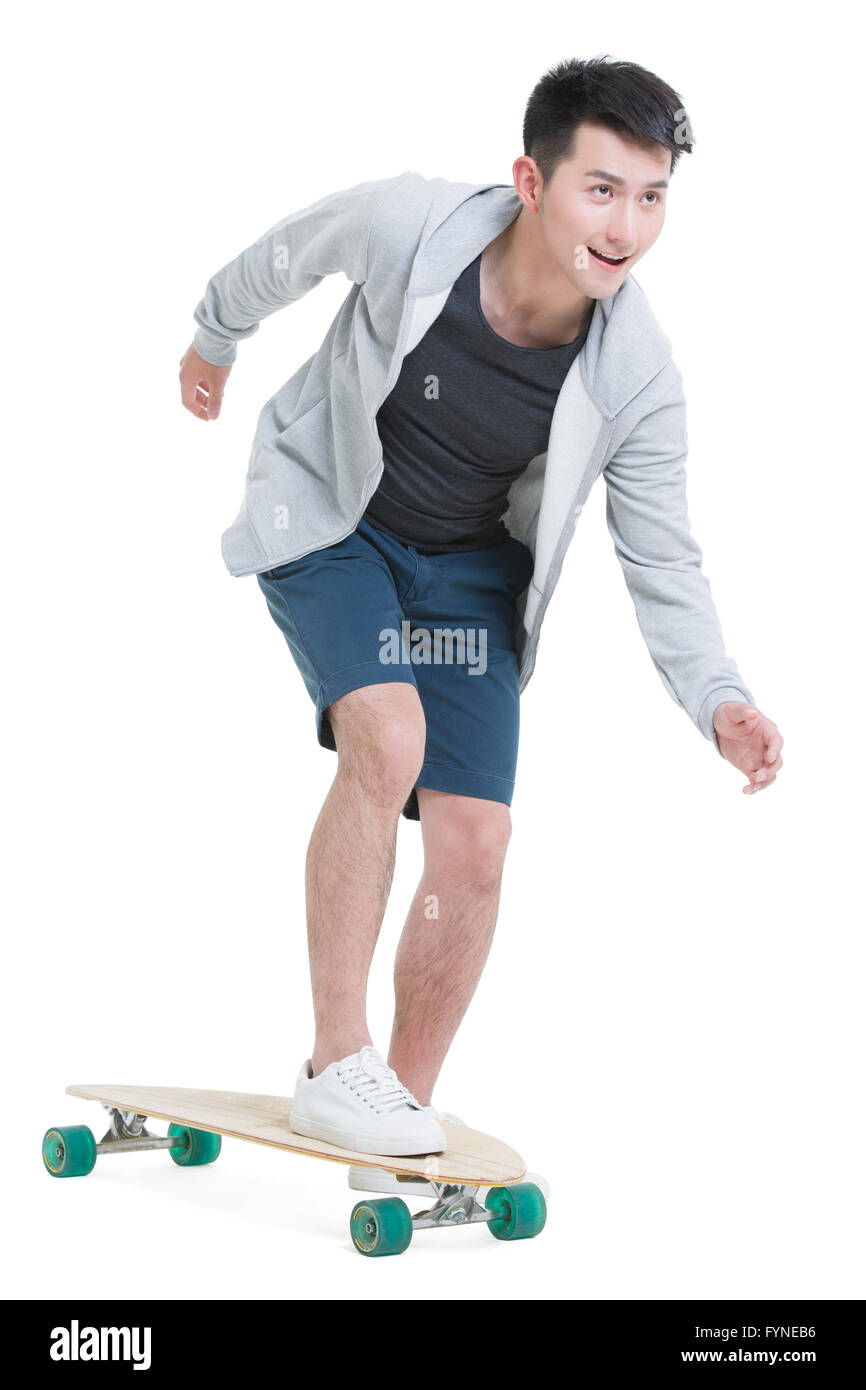 Happy young man skateboarding Stock Photo - Alamy