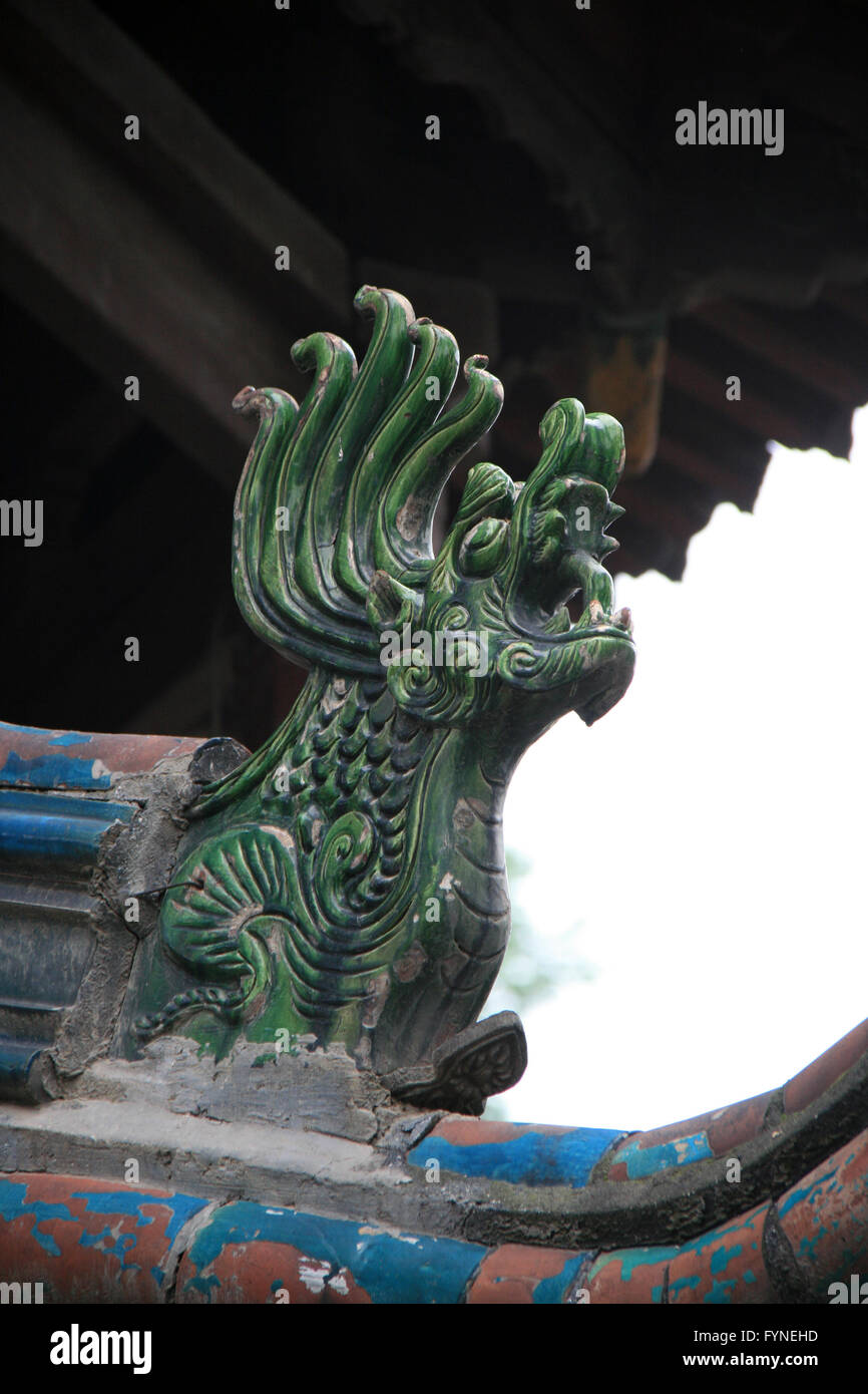 A sculptured dragon decorates the roof of a pagoda closed to the great ...