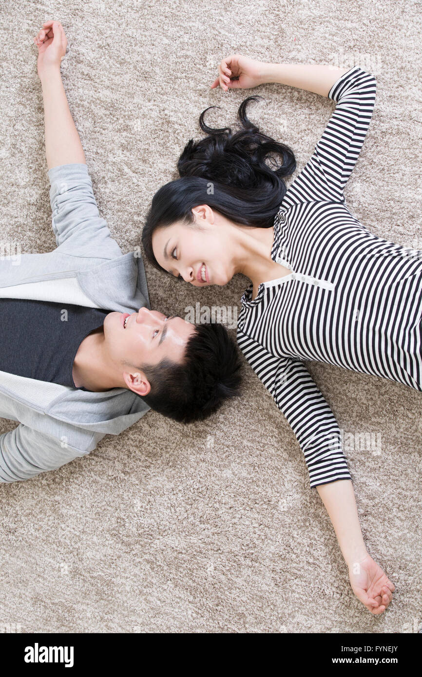 Couple lying down on rug hi-res stock photography and images - Alamy