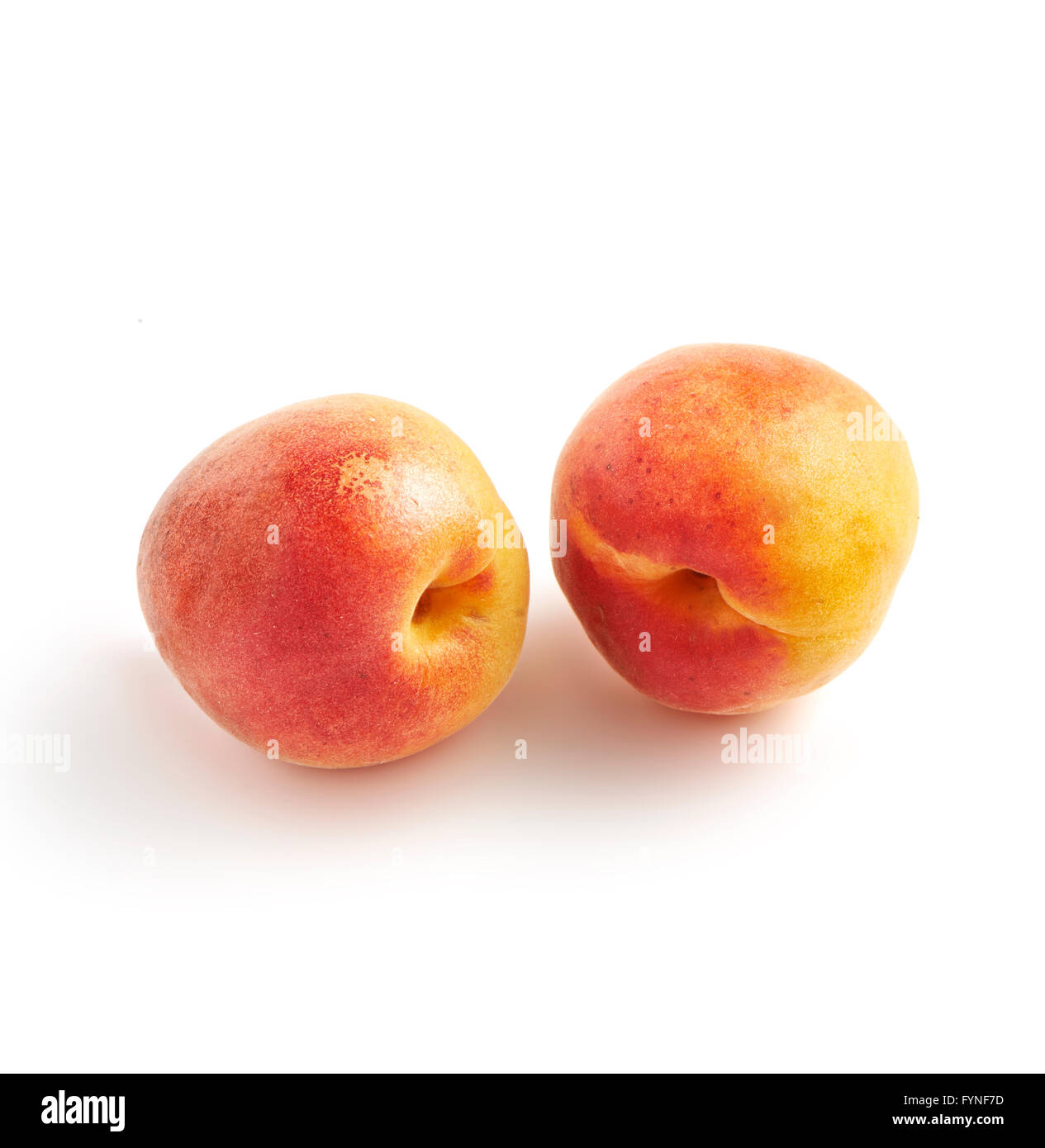Still Life of Two Whole Ripe Nectarines on White Background with Copy ...