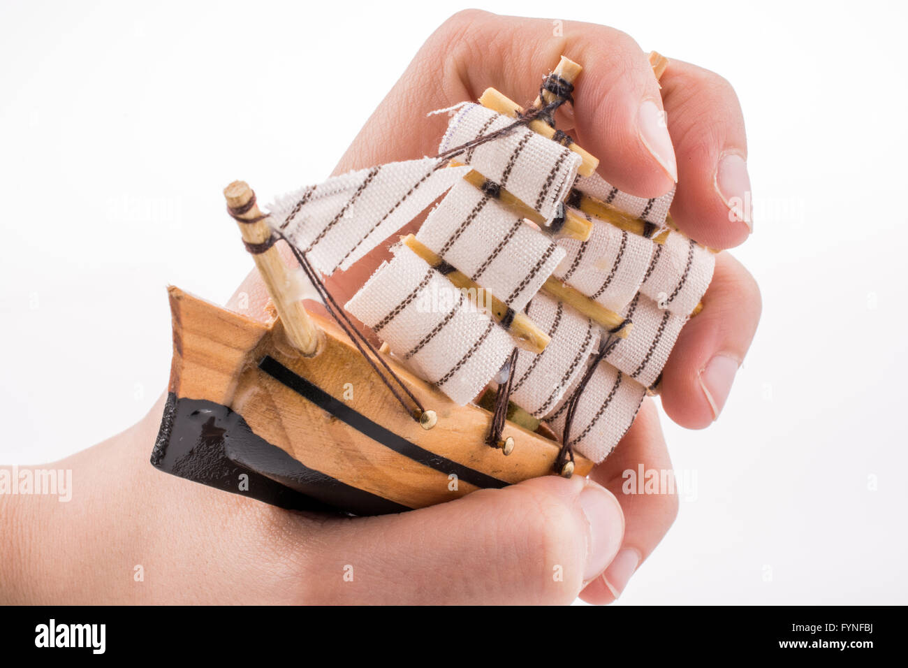 Hand holding a Little model sailboat on a white background Stock Photo ...