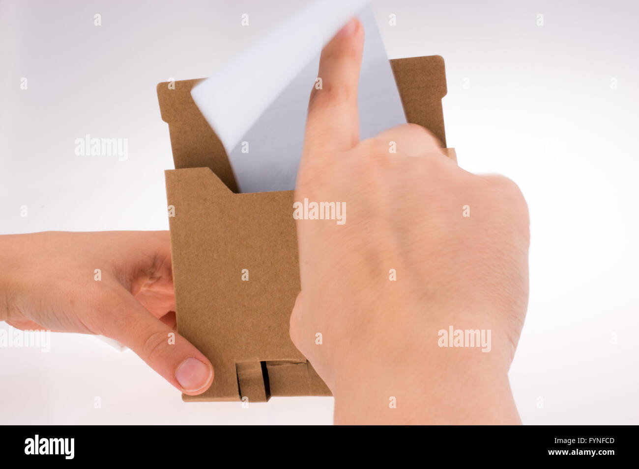Hand reaches paper holder stand on white background Stock Photo - Alamy