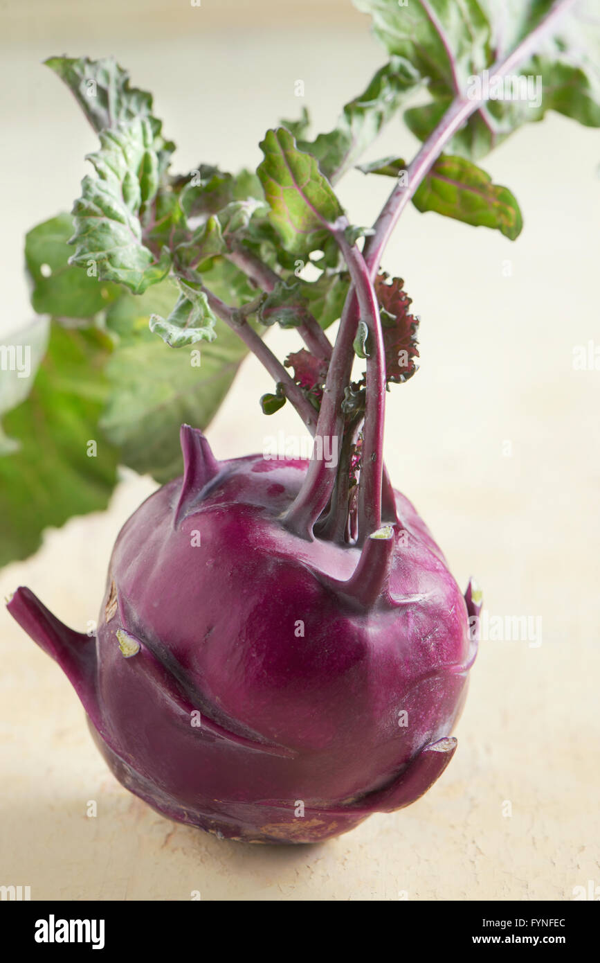 Whole farm fresh red kohlrabi with attached leaves displayed on a ...