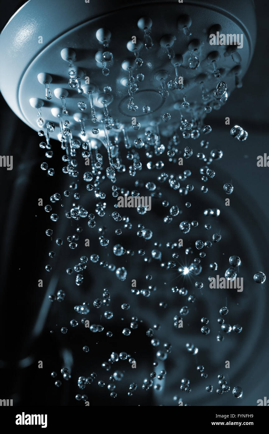 closeup view of water flowing out of shower in dark Stock Photo - Alamy