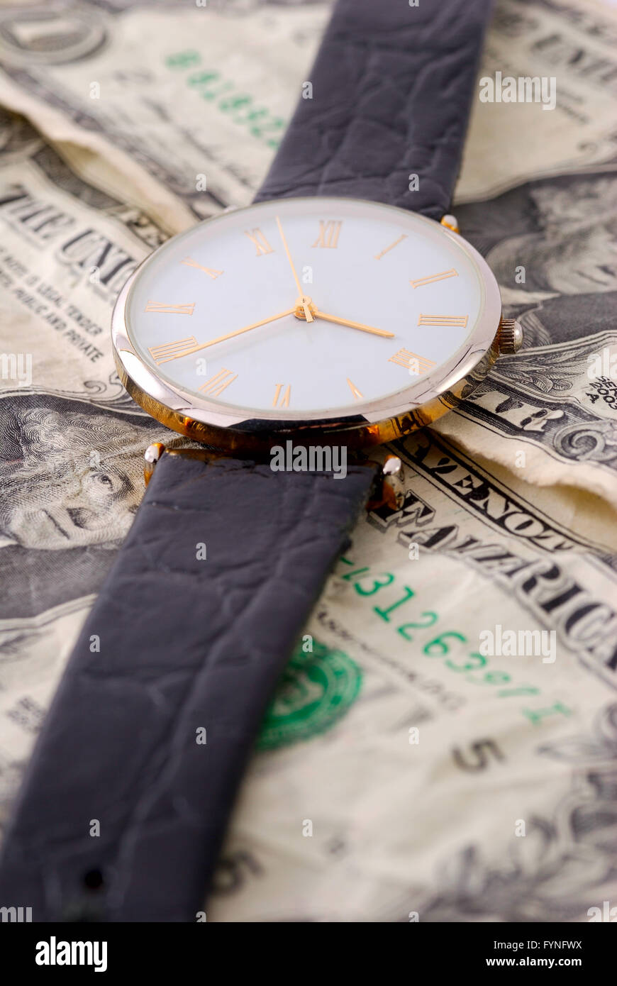 Watch and money Stock Photo - Alamy