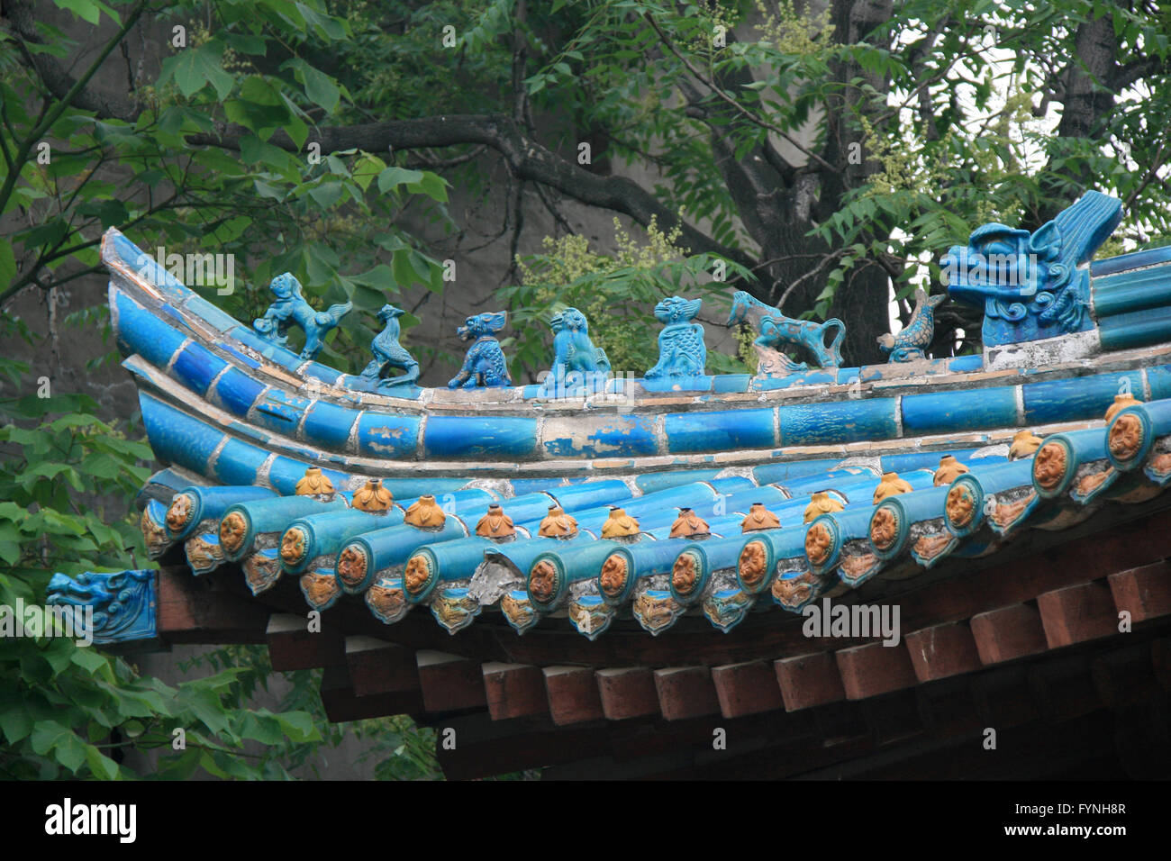 Sculptured figurines decorate the glazed tiles roof of the great mosque ...