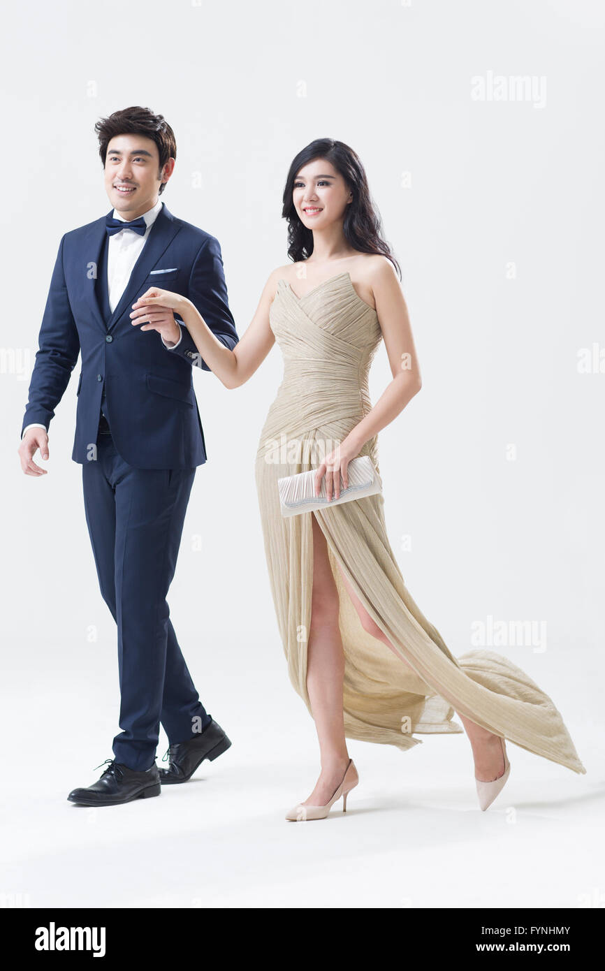 Elegant young couple walking Stock Photo - Alamy