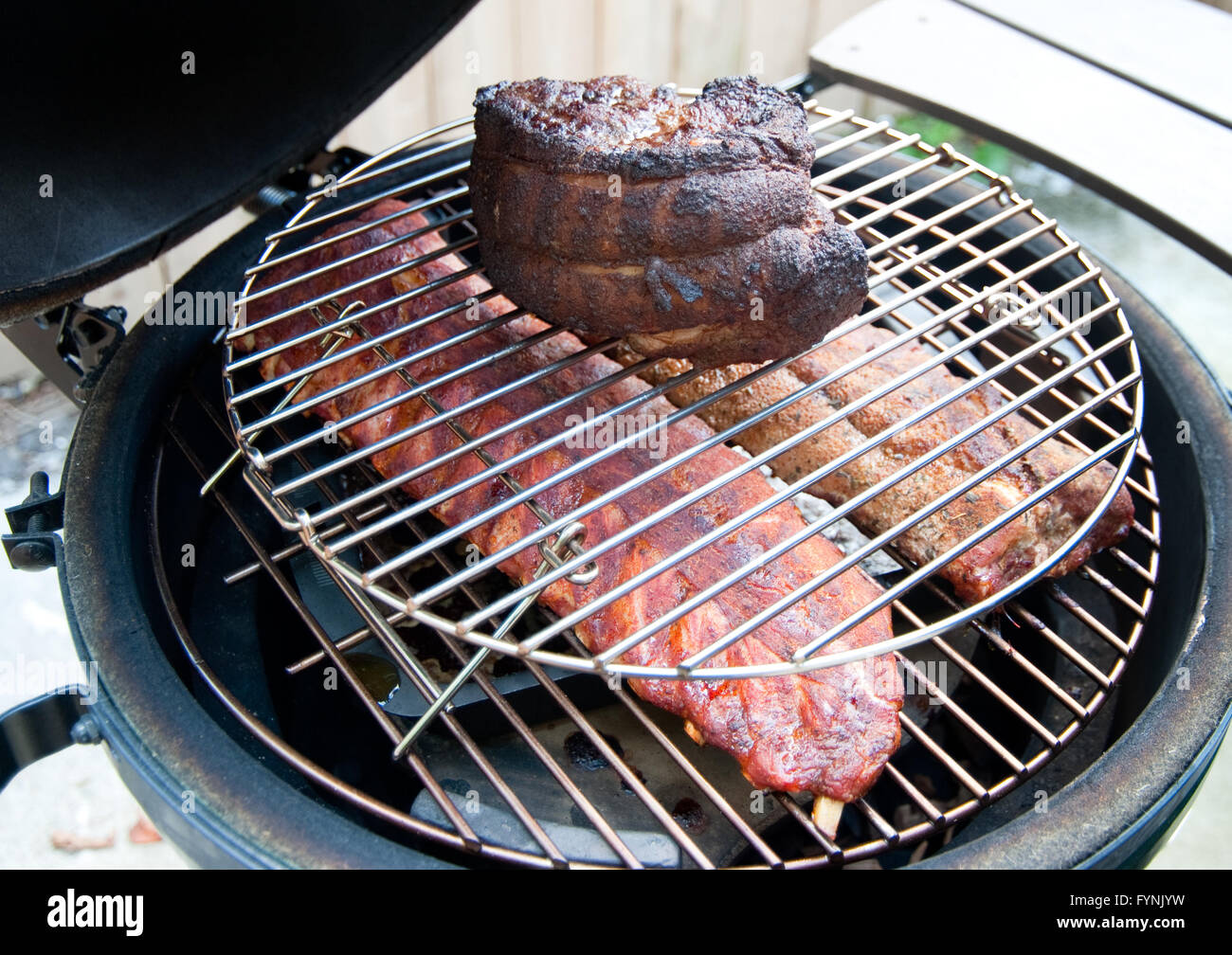 Pork shoulder and ribs on a grill Stock Photo - Alamy