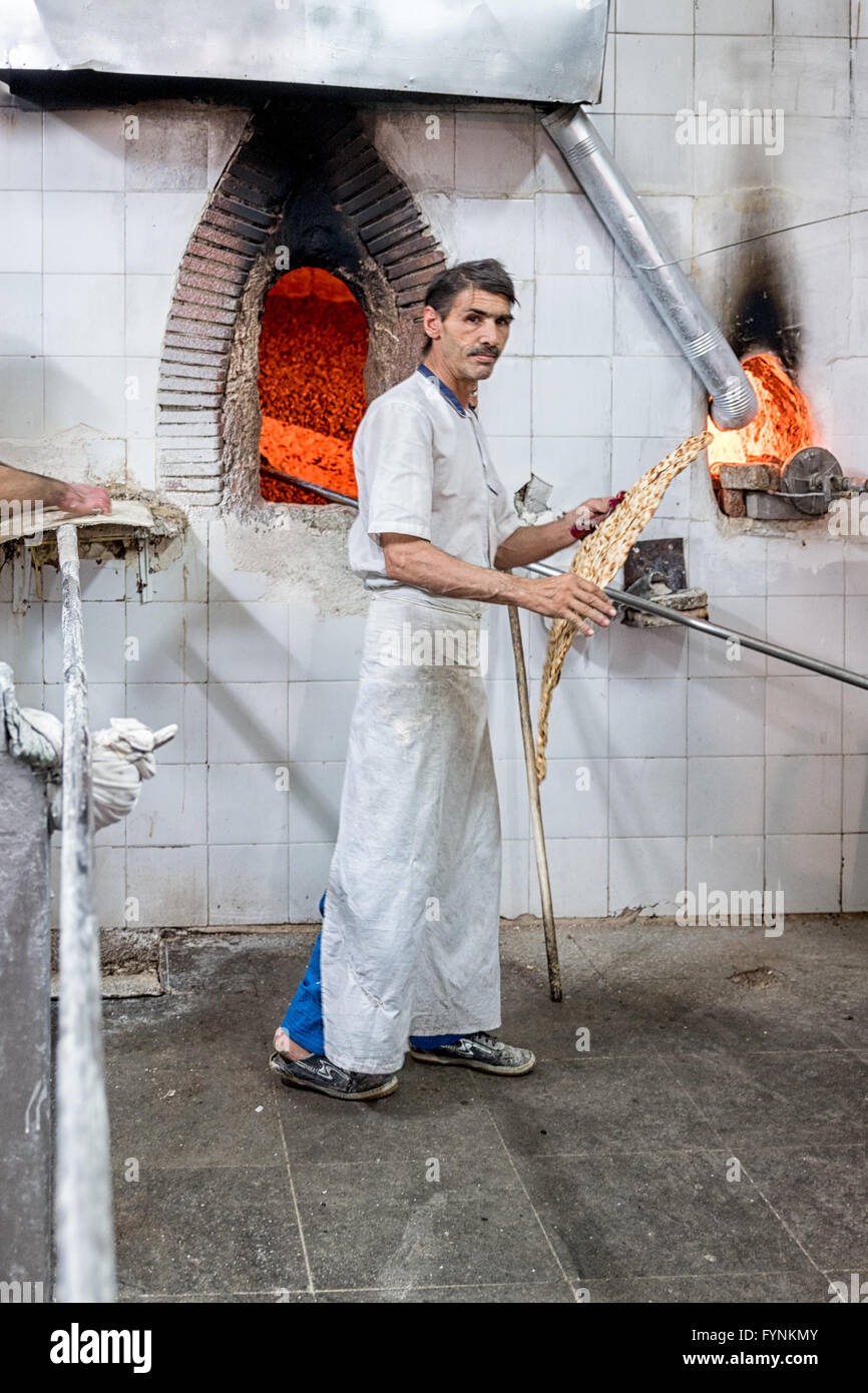 Iranian bakers making sangak bread that is cooked on hot stones Stock ...