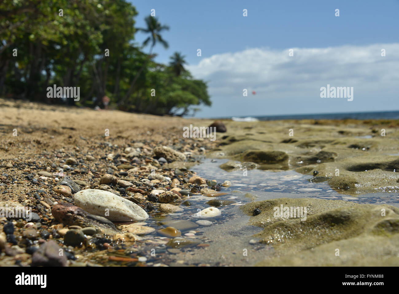 A closeup of the empty Steps Beach in Rincon, Puerto Rico, with blurred ...