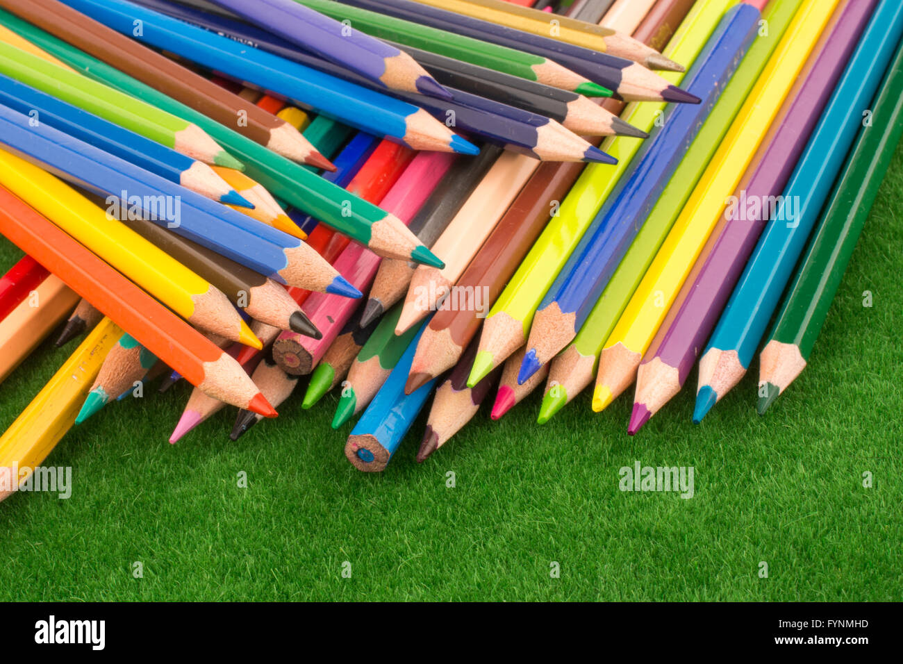 Color pencils scattered on green grass Stock Photo - Alamy