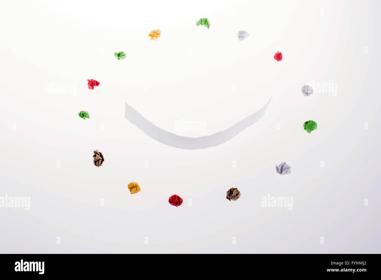 Colorful crumpled papers form a round shape around a smile Stock Photo ...
