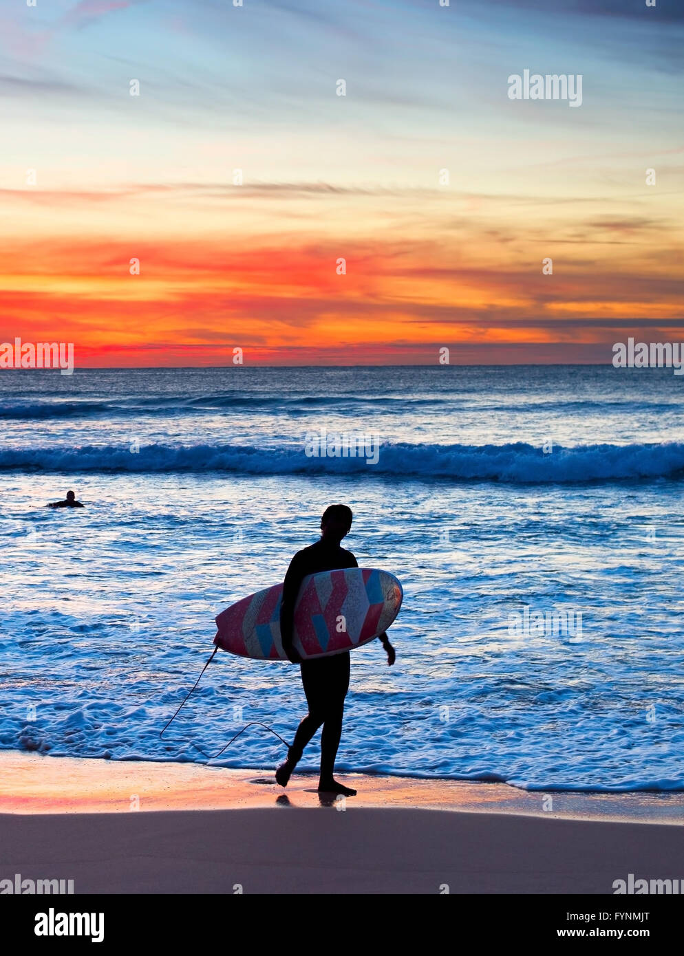Surfer with surfboard walking on the beach Stock Photo - Alamy