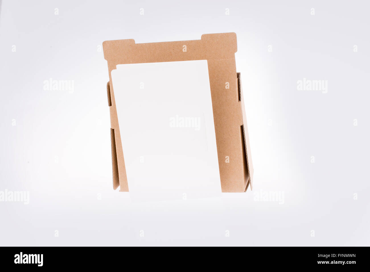 Hand reaches paper holder stand on white background Stock Photo - Alamy