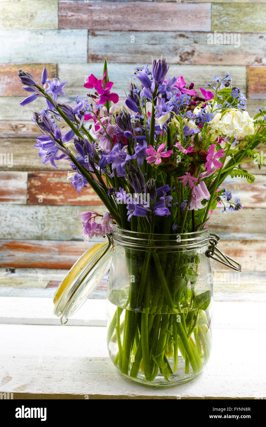 Jar with fresh colorful bouquet spring forest flowers and hyacinths ...
