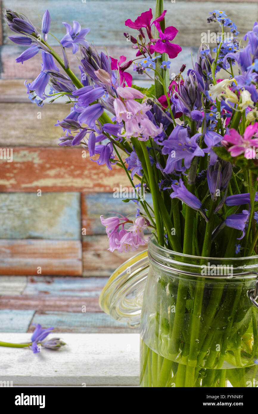 Jar with fresh colorful bouquet spring forest flowers and hyacinths ...