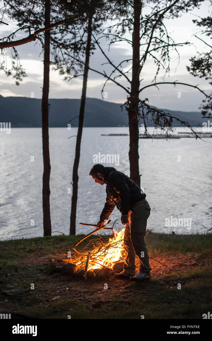 Man lights a fire in the fireplace in nature at night Stock Photo - Alamy