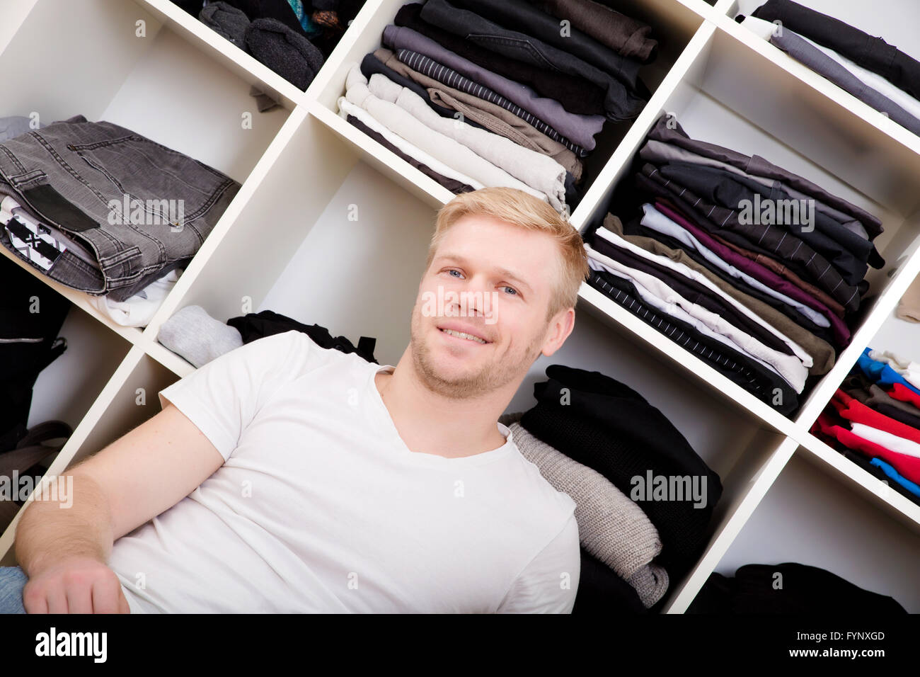 Young man with his wardrobe Stock Photo - Alamy
