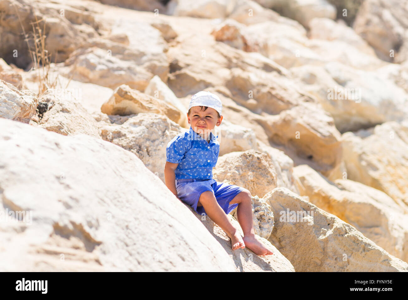 Sad boy sitting on stone hi-res stock photography and images - Alamy