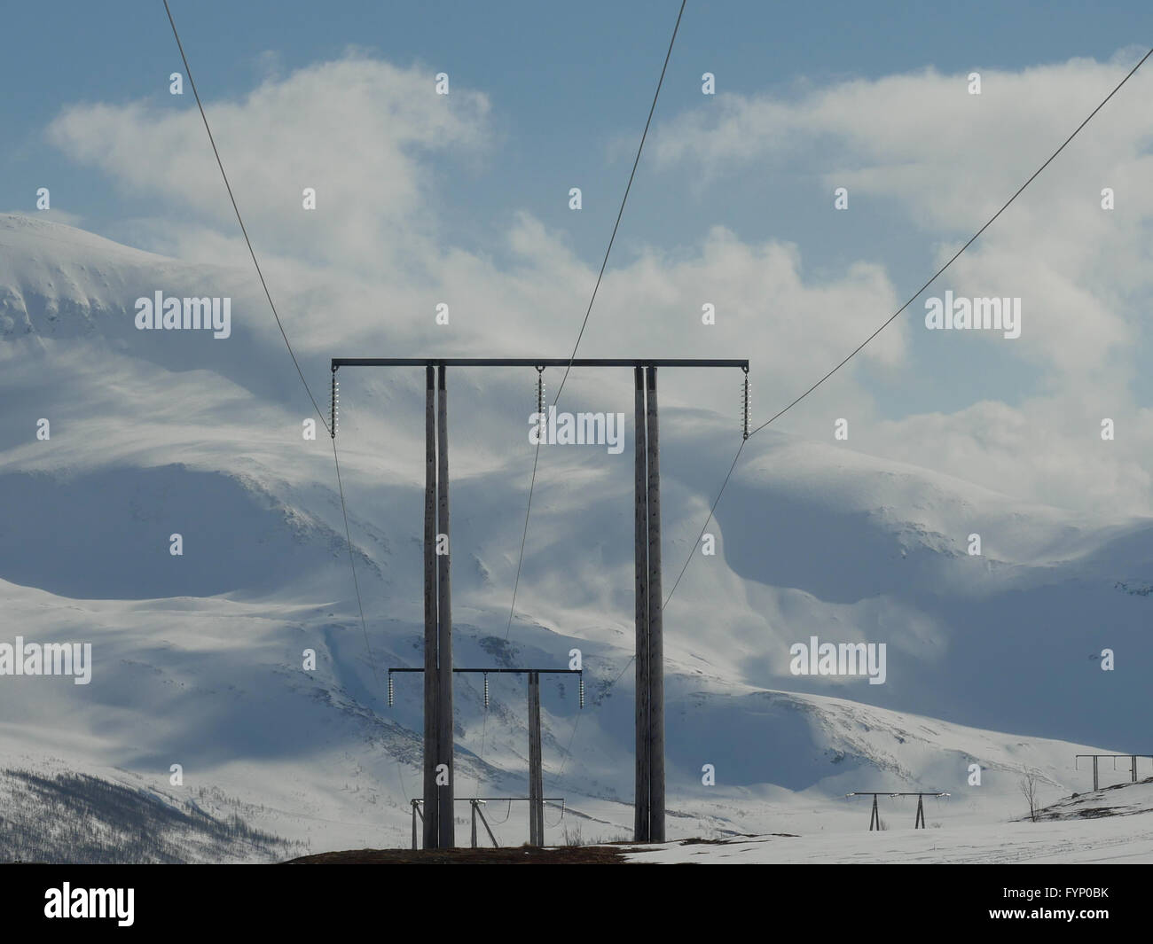 Electricity lines running over mountain range Stock Photo - Alamy