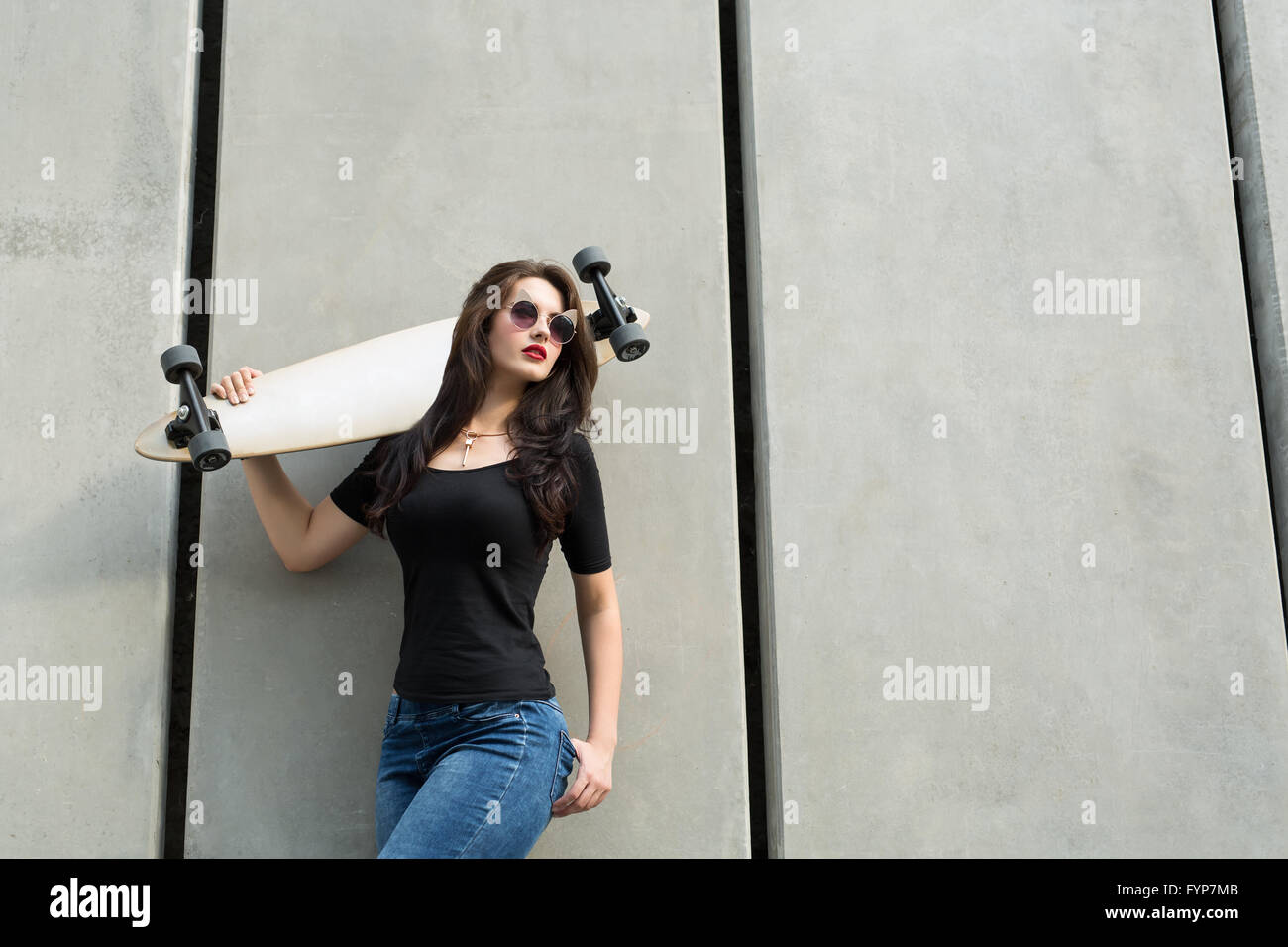 Stylish teenager girl with a longboard Stock Photo - Alamy