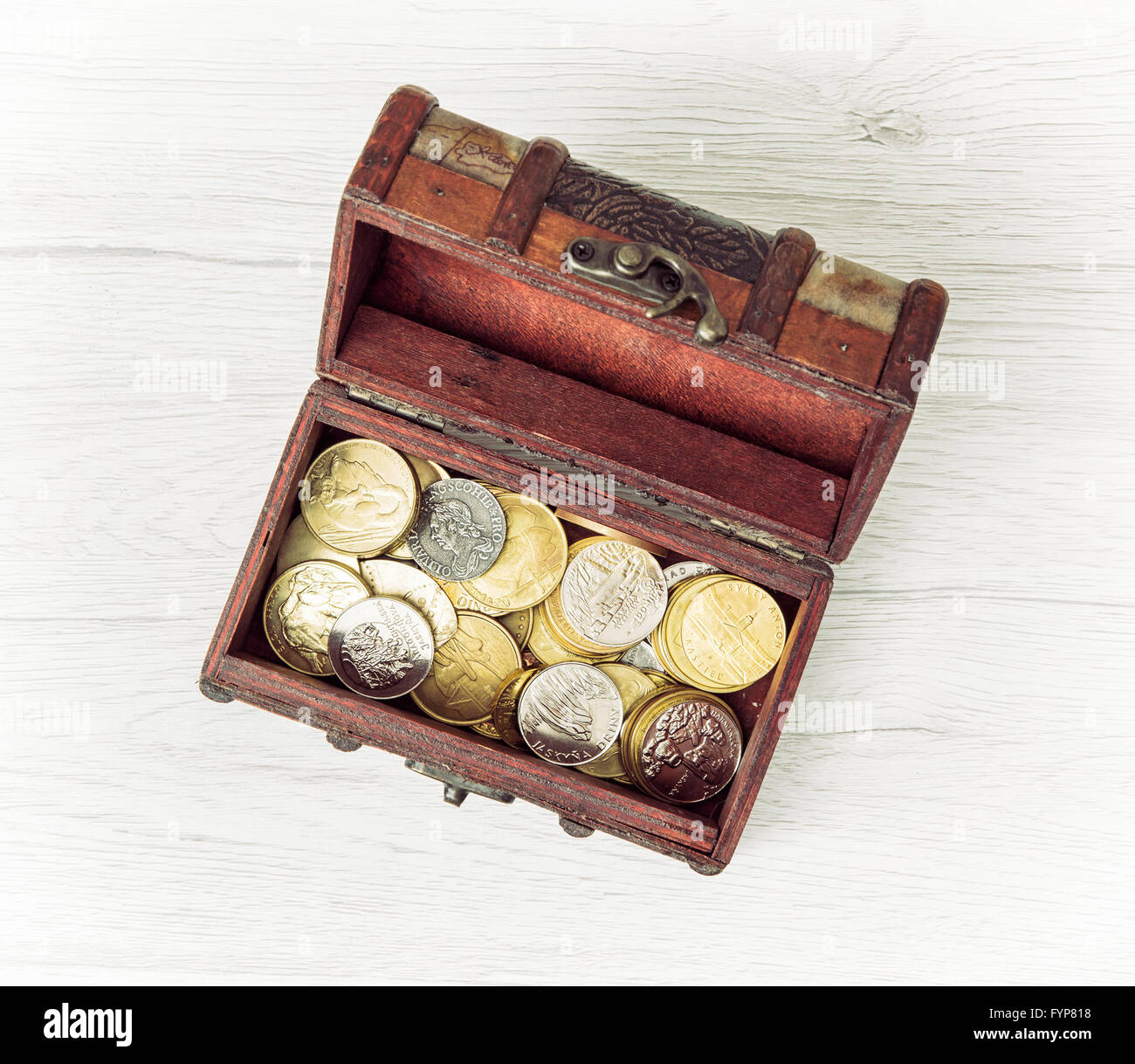 Retro wooden money chest filled with coins. Wealth theme. Saving money ...