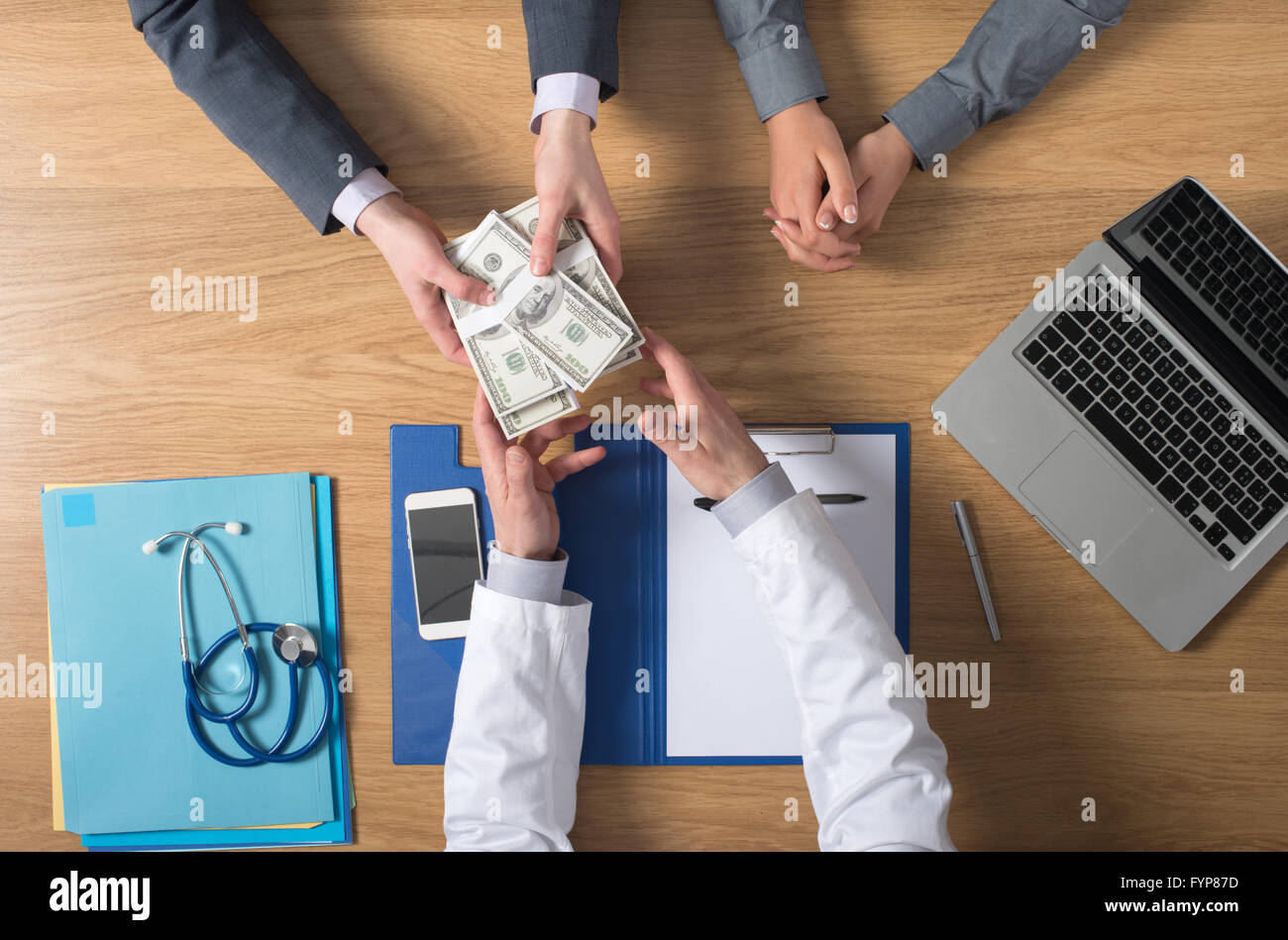 Male patient having a medical visit and bribing a greedy doctor with a ...