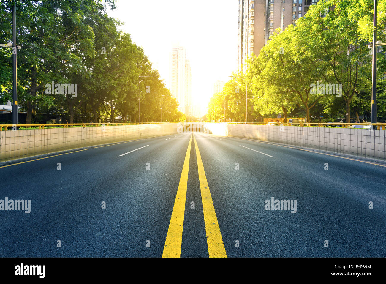bi-directional road with the doubled solid lines under sunshine Stock ...